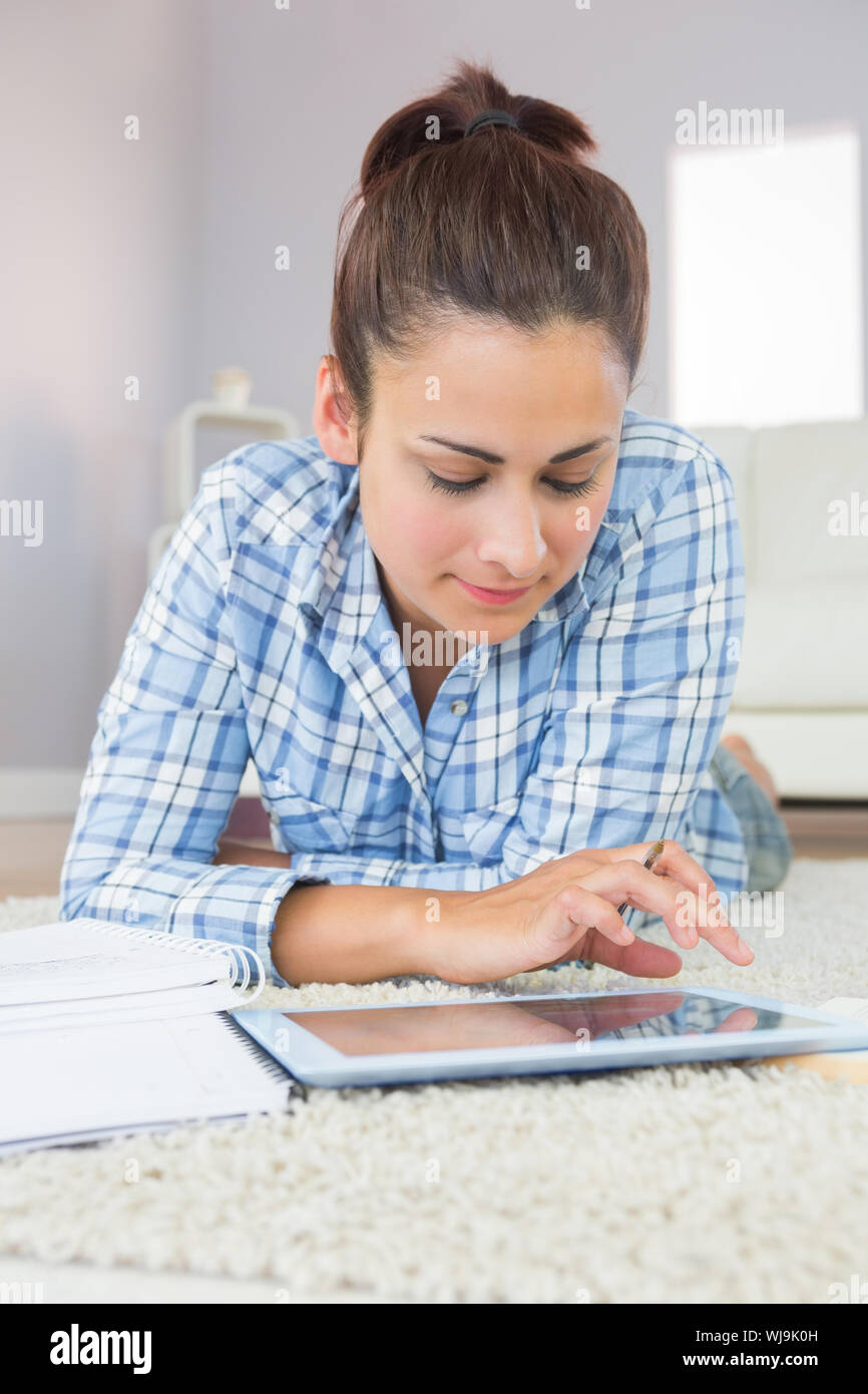 Concentrating woman lying on floor hi-res stock photography and images ...