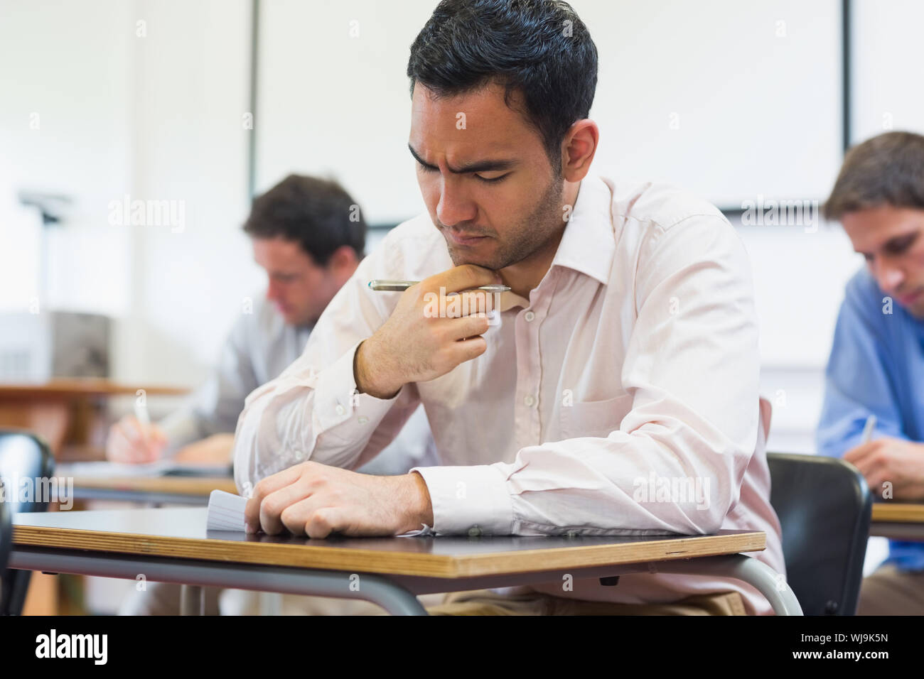 Three mature students taking notes in lecture in college Stock Photo ...