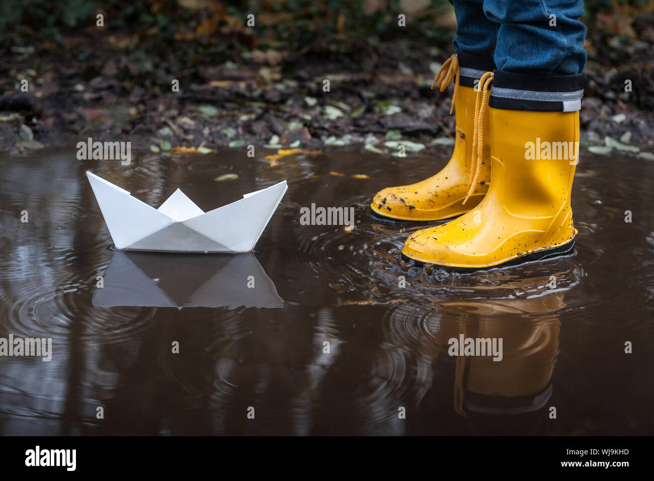 Paper boat puddle hi-res stock photography and images - Alamy