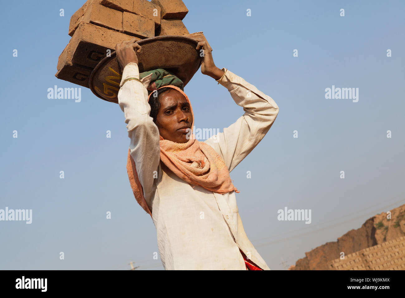 Carrying Bricks On Head Stock Photos & Carrying Bricks On Head Stock ...