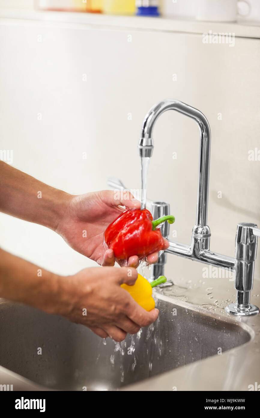 Kitchen porter washing vegetable in professional kitchen Stock Photo ...