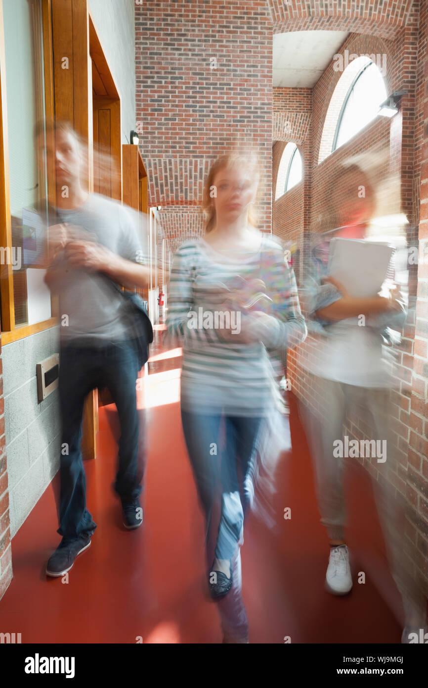 Students walking through hallway toward camera in school Stock Photo ...