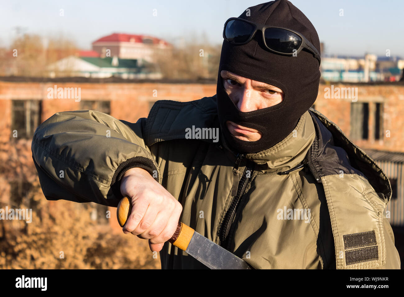 Masked action movie with edged weapons and a menacing look Stock Photo ...