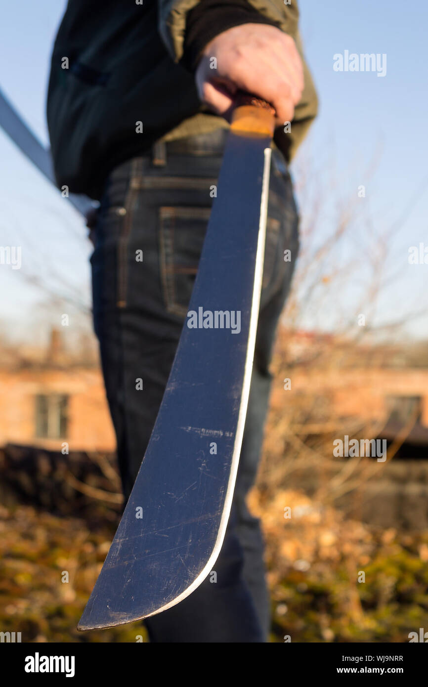 Blade machete in hand Stock Photo - Alamy