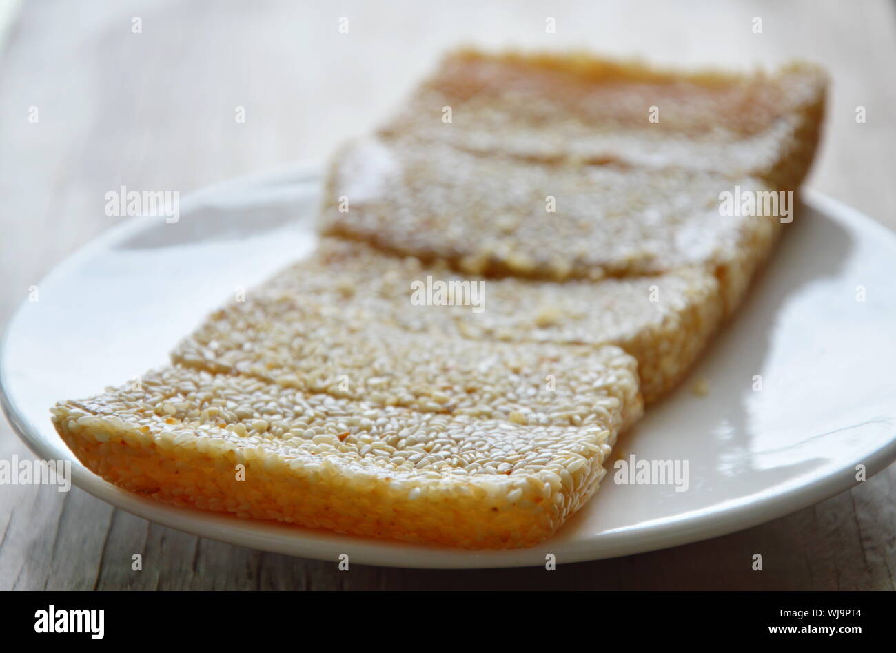 soft sesame bar Chinese sweetmeat on dish Stock Photo - Alamy