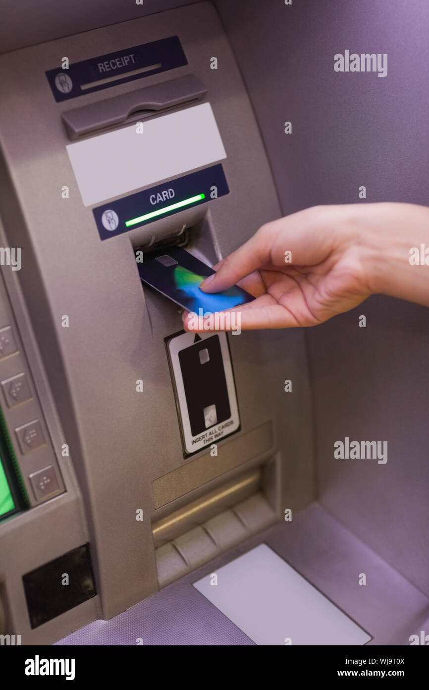 Close up of hand pulling in debit card at an ATM Stock Photo - Alamy