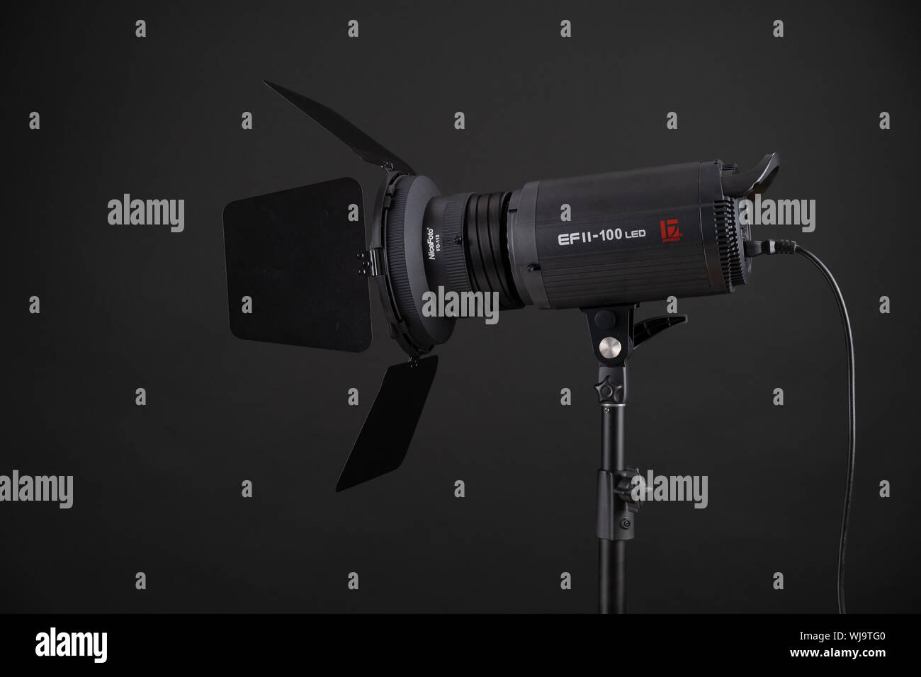 Studio professional flash is a pulsed light source on black background ...