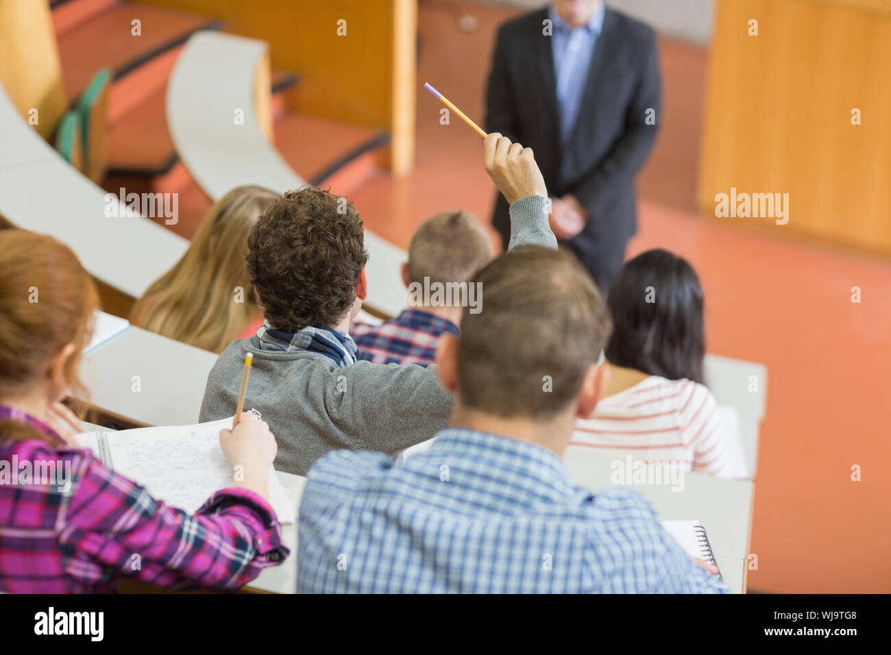 Rear view of students sitting at the college lecture hall Stock Photo ...