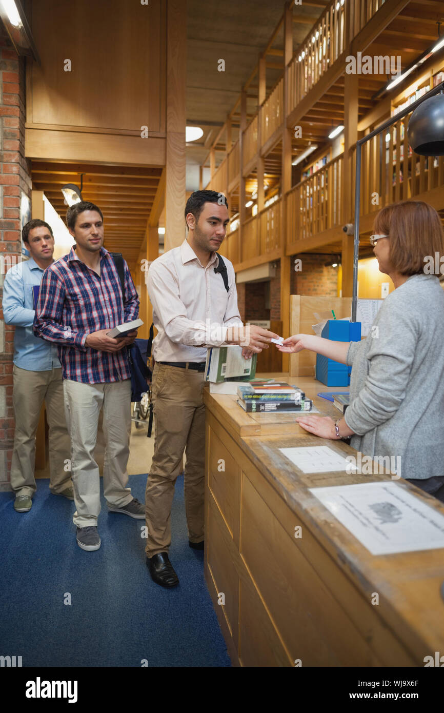 Queue at the library desk Stock Photo - Alamy