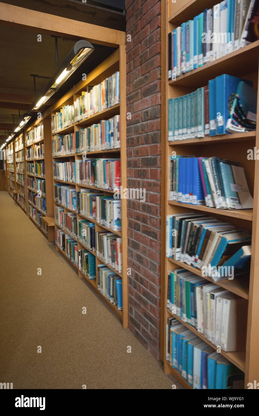 Row of bookshelves filled with books in a library Stock Photo - Alamy