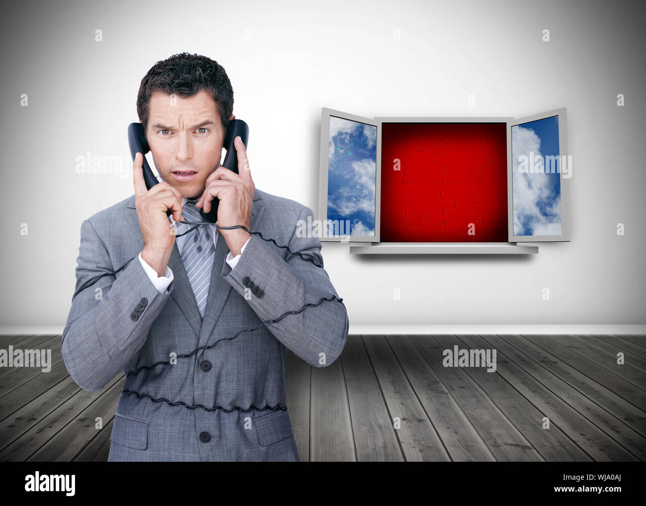 Angry businessman wrapped in cables phoning in front of open window ...