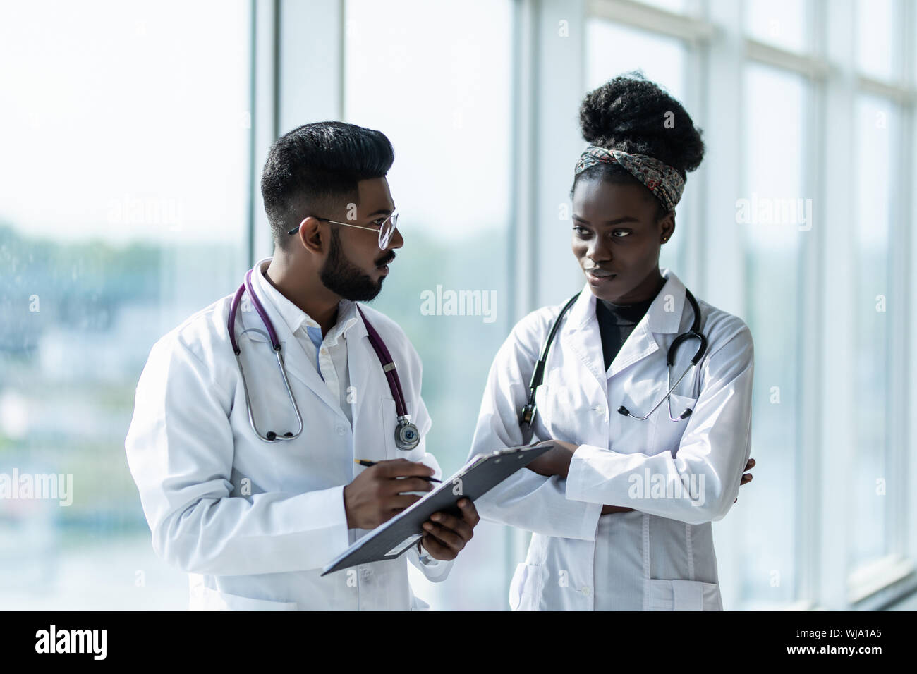 Portrait of doctors looking at a document in an office Stock Photo - Alamy