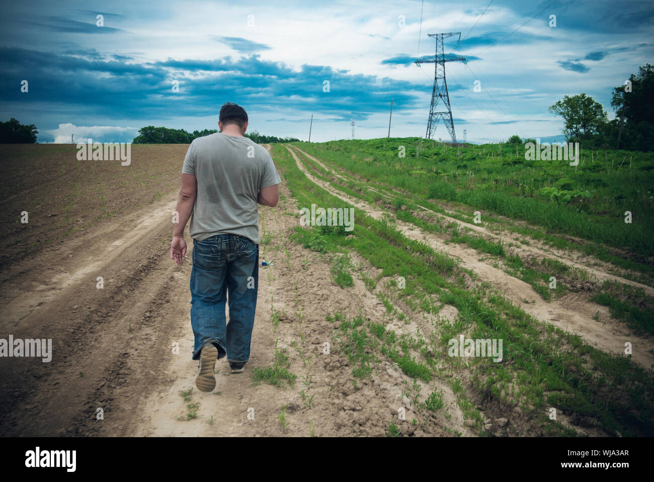 Man walking on country road hi-res stock photography and images - Alamy