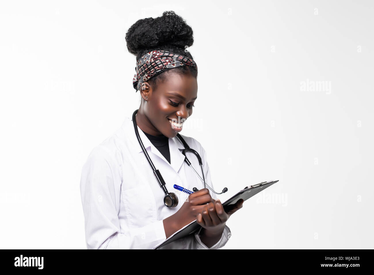happy african medical intern doctor writing on clipboard Stock Photo ...