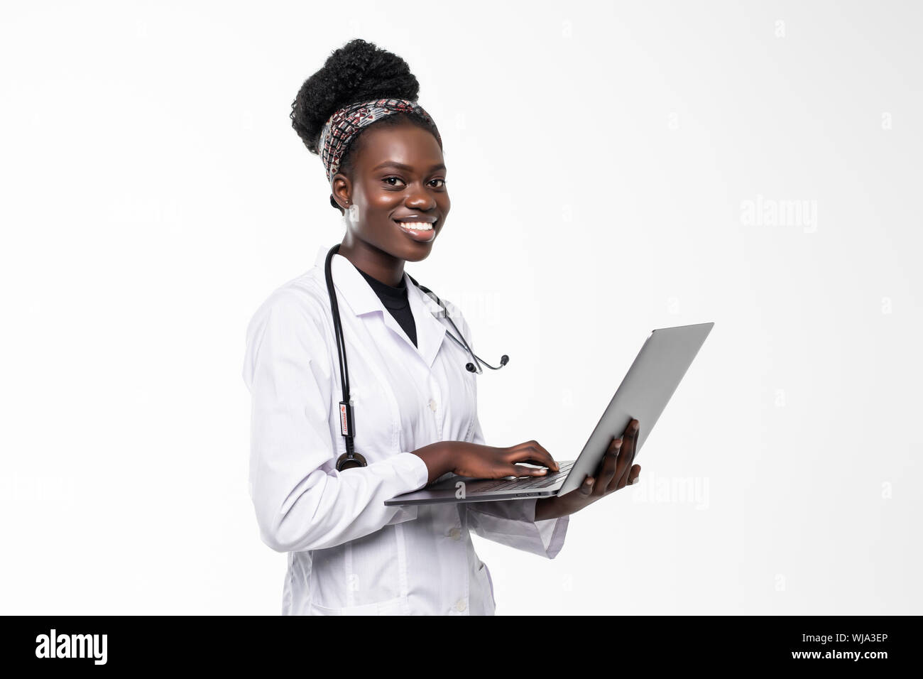 Beautiful African American woman doctor or nurse holding a laptop ...