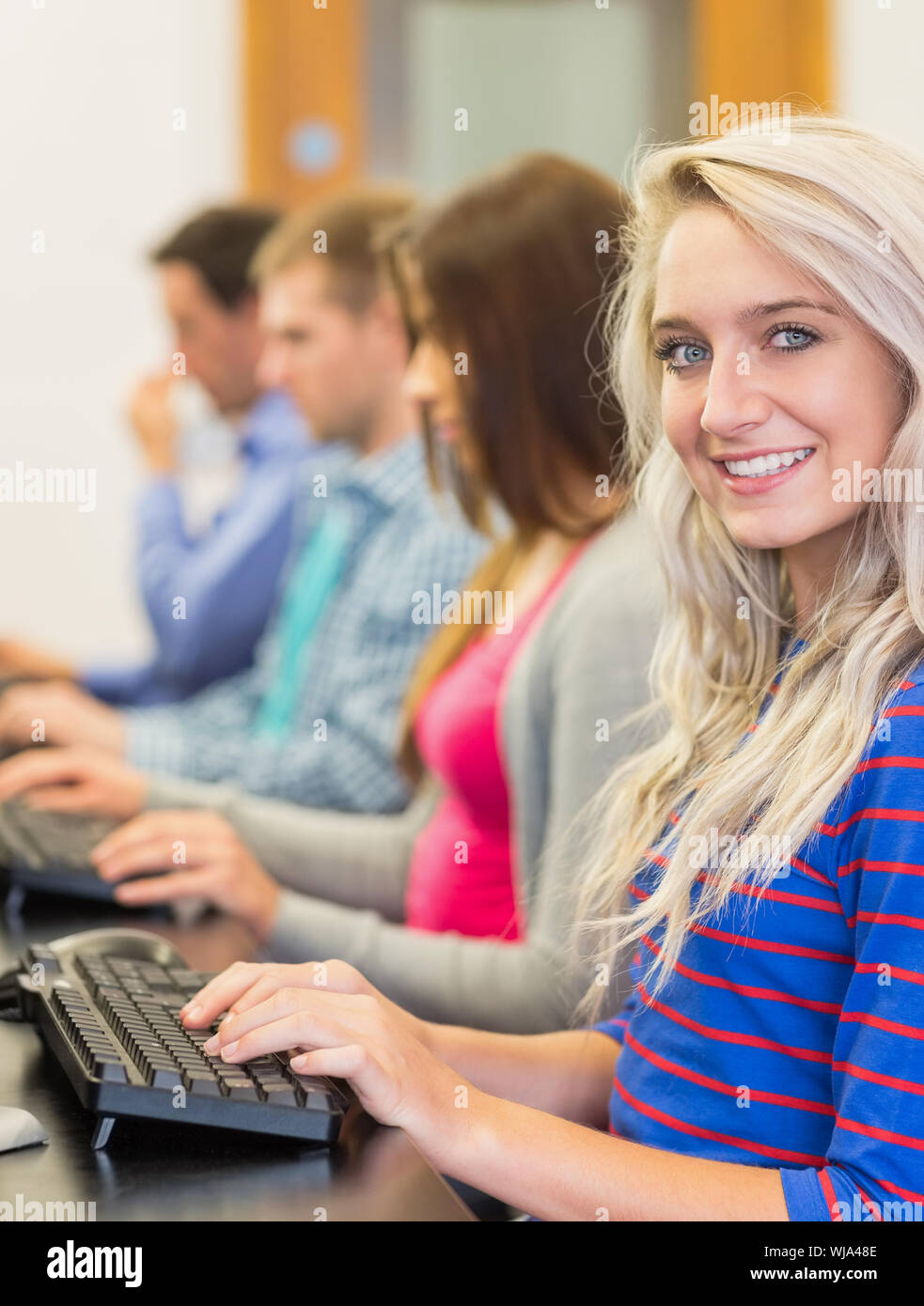 Side view of young students using computers in the computer room Stock ...