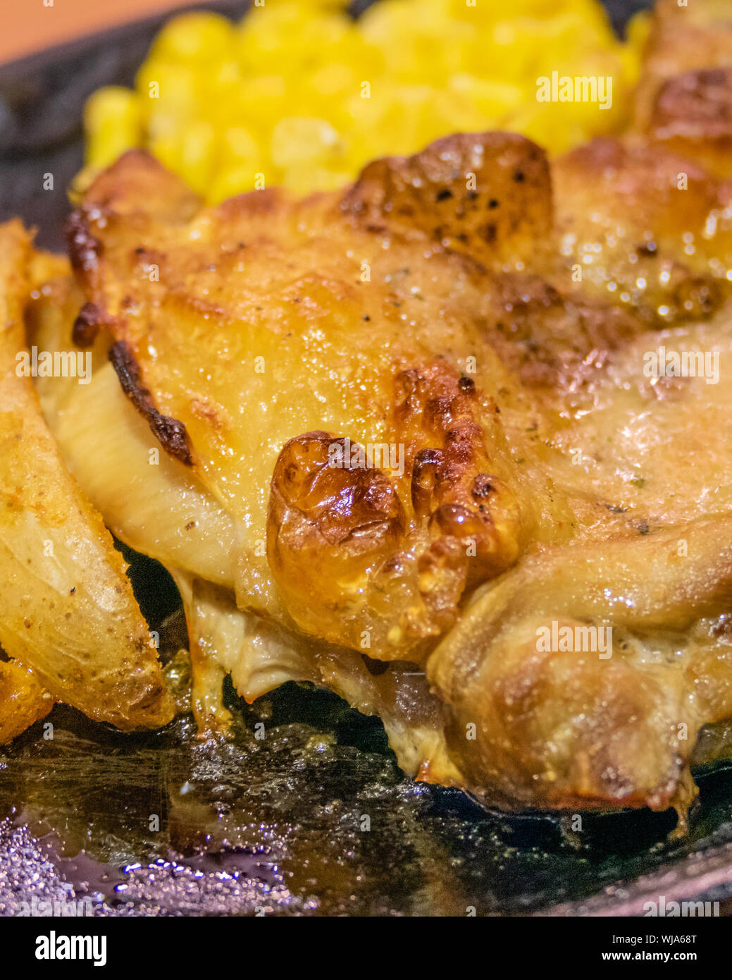 Chicken, French fries, and corn in metal plate Stock Photo - Alamy