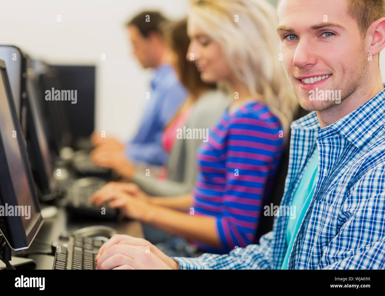 Side view of young students using computers in the computer room Stock ...