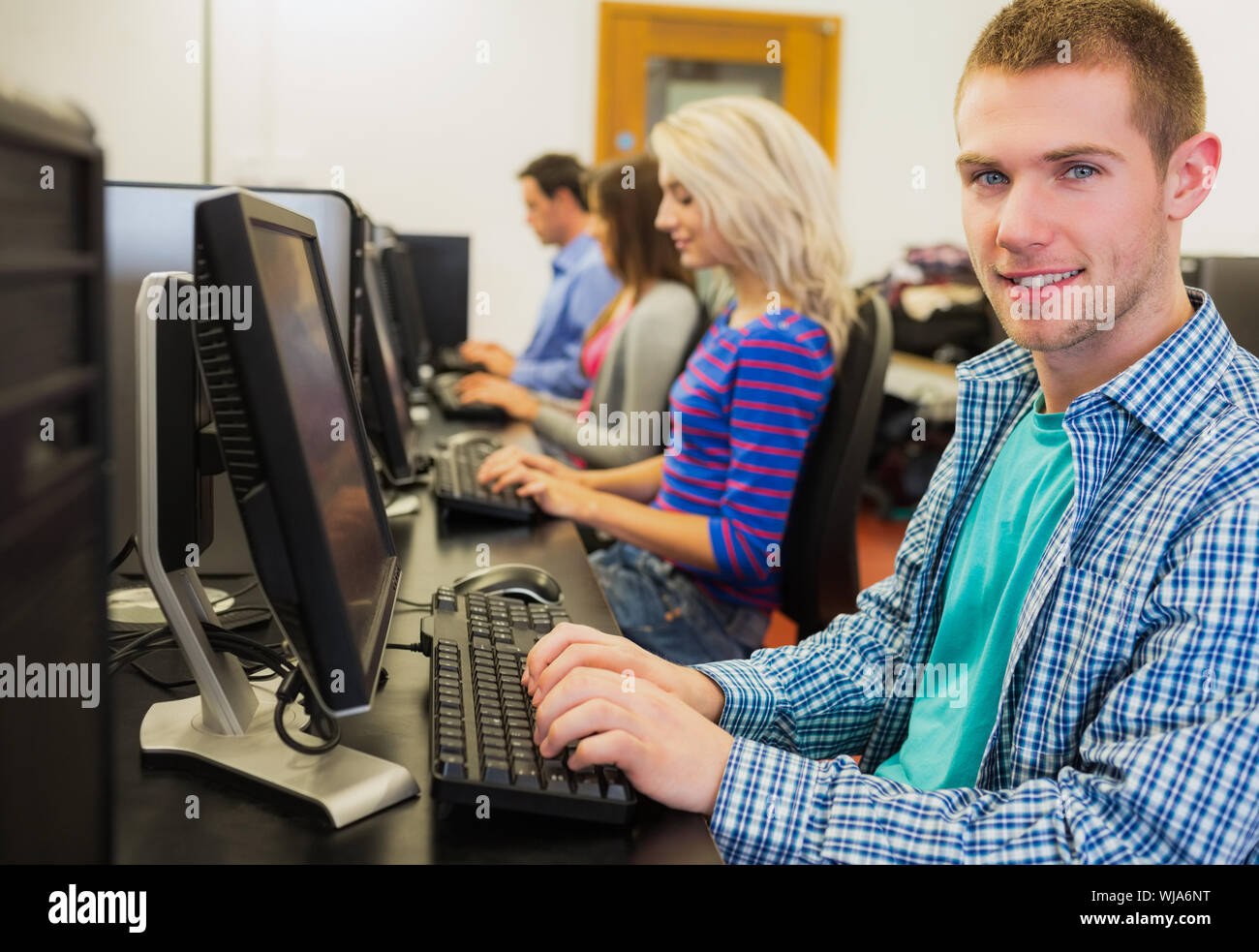 Side view of young students using computers in the computer room Stock ...