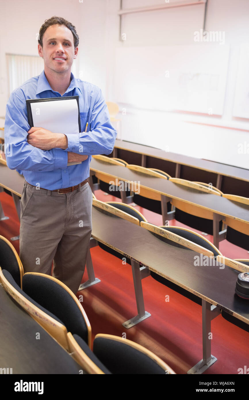Portrait of a male teacher with notepad in the lecture hall Stock Photo ...