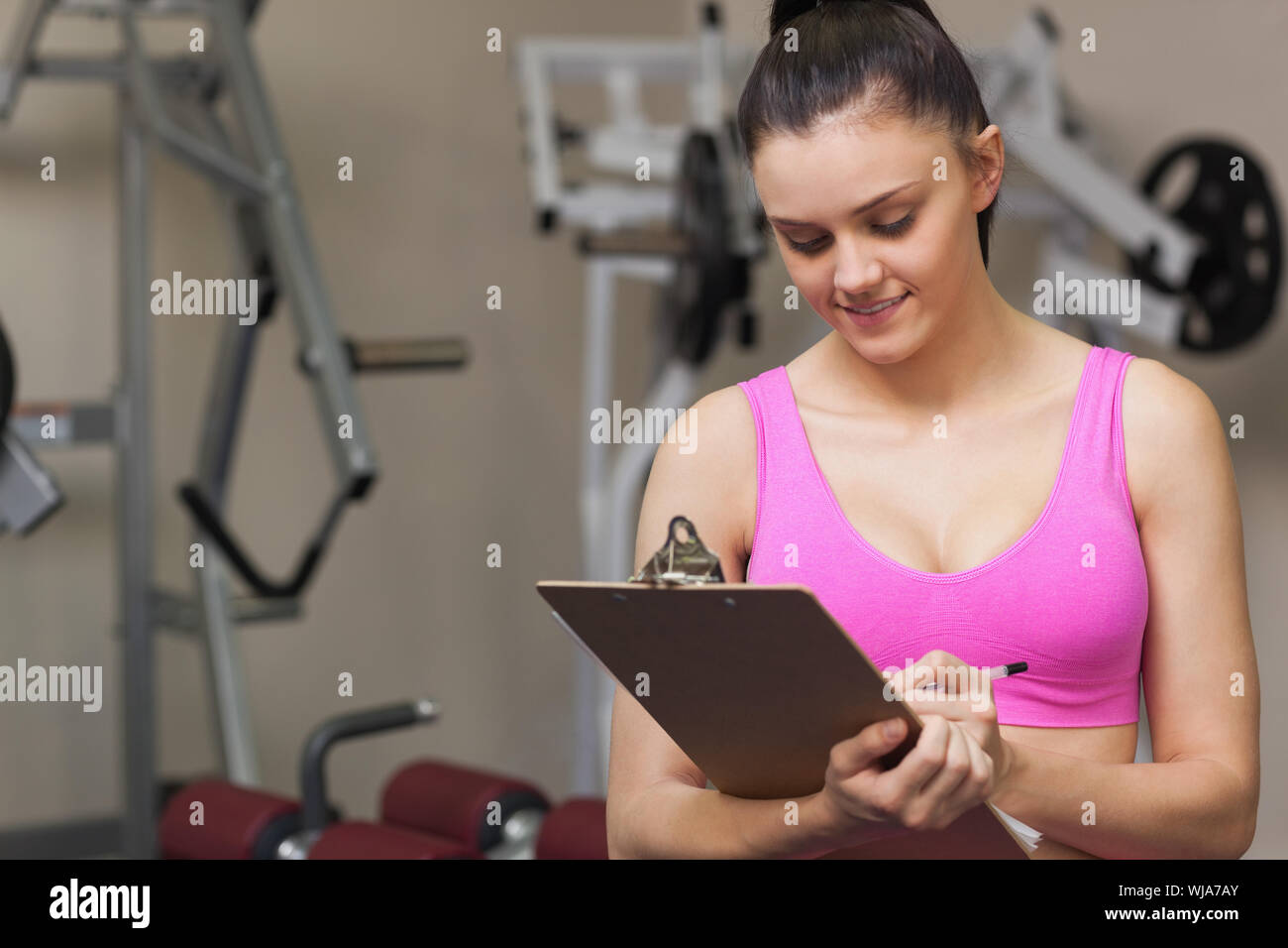 Smiling fitness woman writing hi-res stock photography and images - Alamy