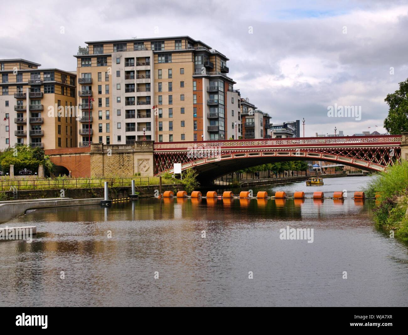 Red Bridge over the river Aire with orange boom with yellow river taxi ...