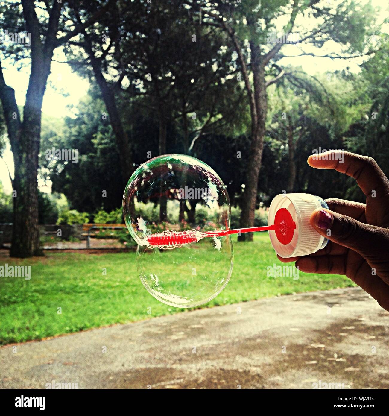 Hand holding bubble wand hi-res stock photography and images - Alamy