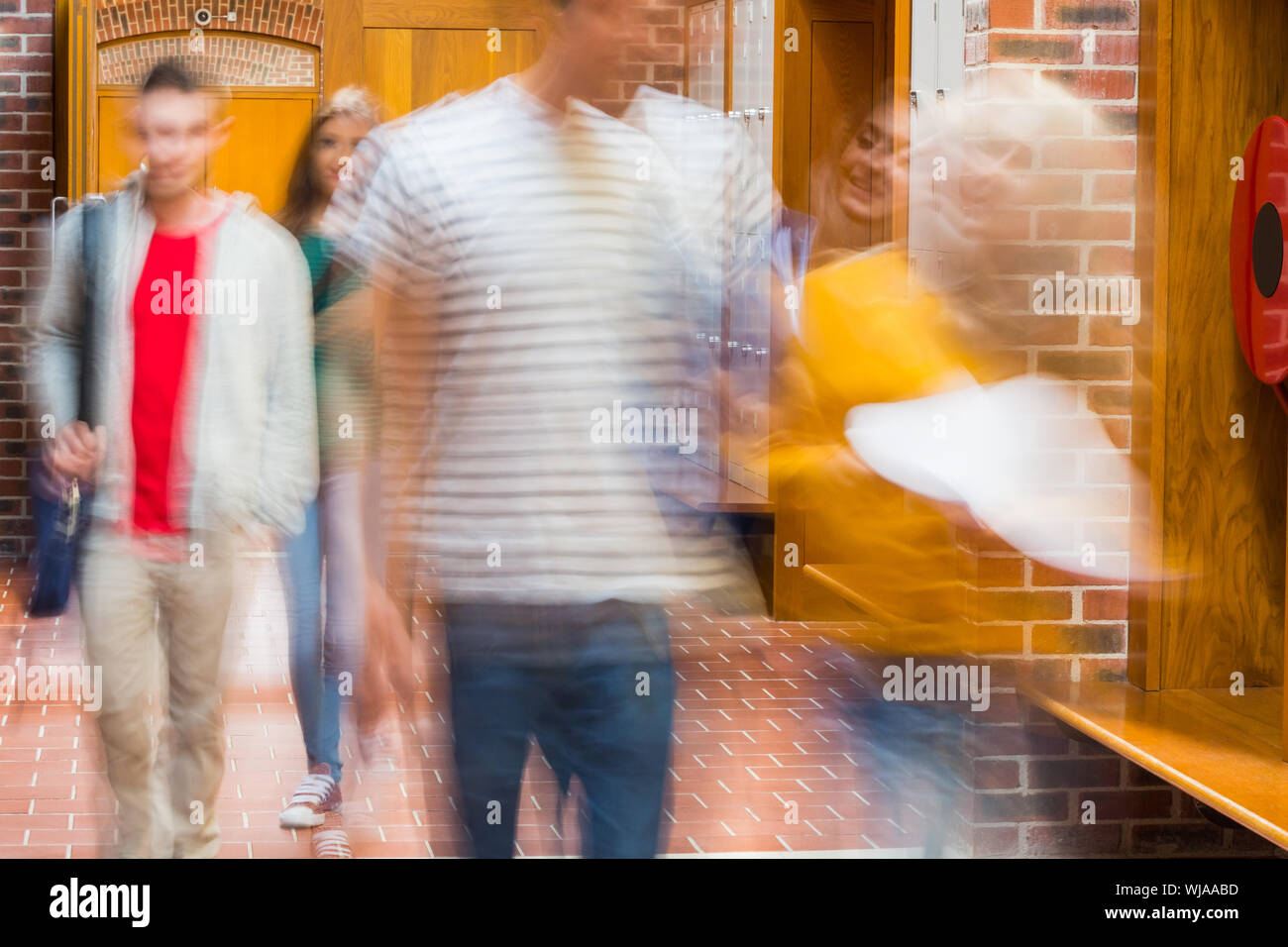 Group of blurred college students walking through corridor Stock Photo ...