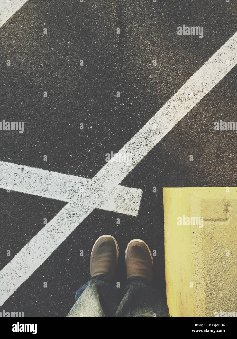 Person standing street markings day hi-res stock photography and images ...
