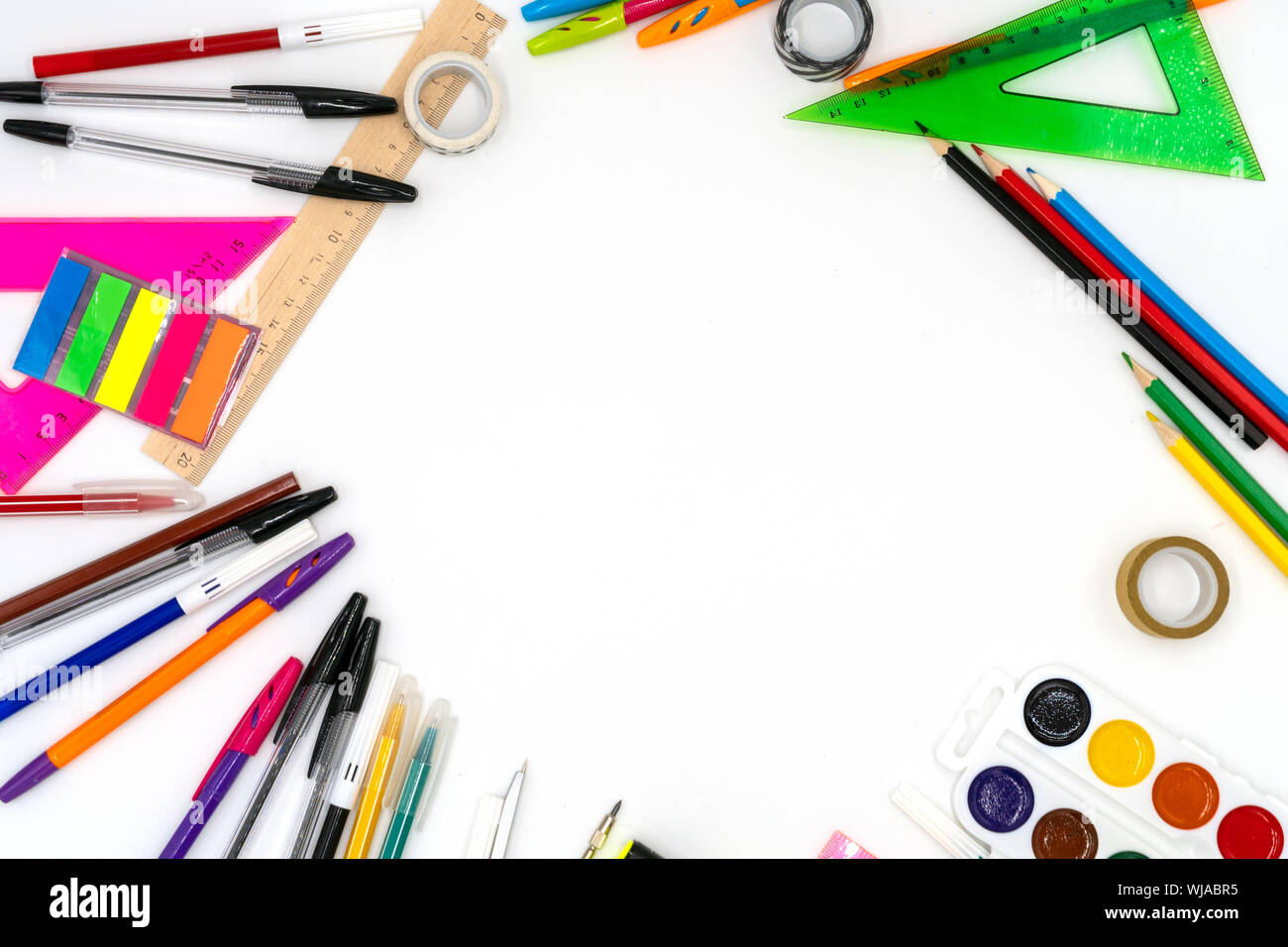 Colorful school supplies in circle arrangement on white background ...