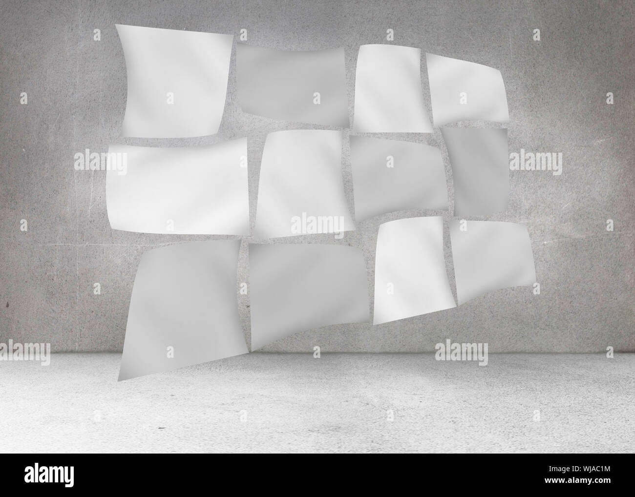 Floating sheets in front of grey wall Stock Photo - Alamy