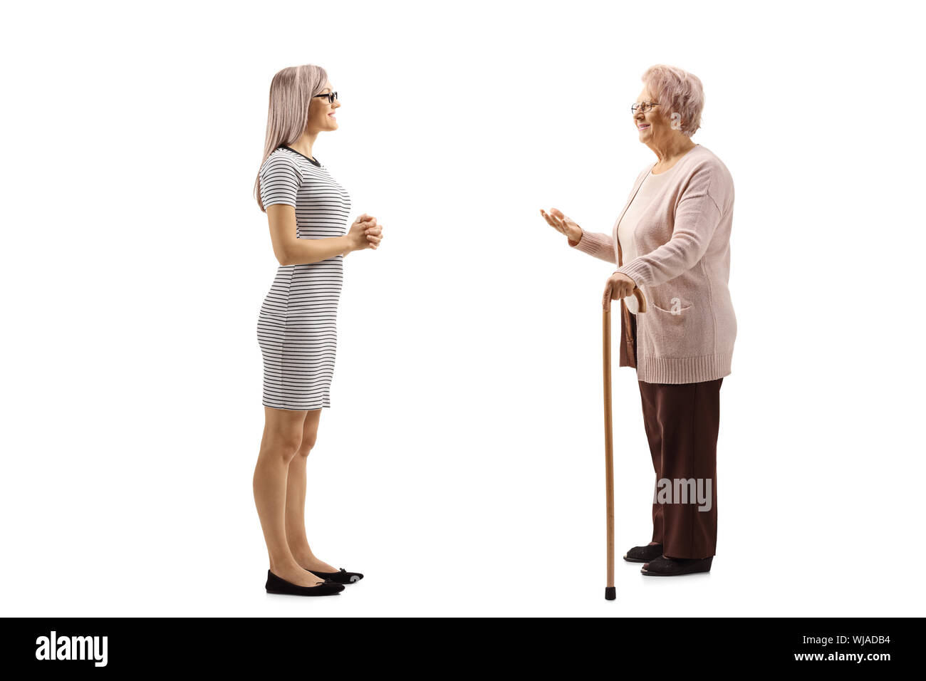 Full length profile shot of a young woman listening to an older woman ...