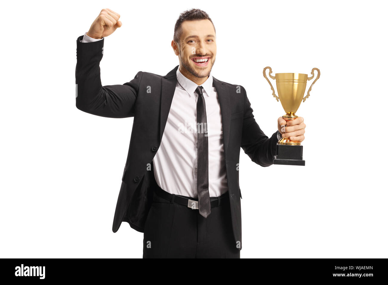 Happy man in a suit holding a gold trophy cup isolated on white ...