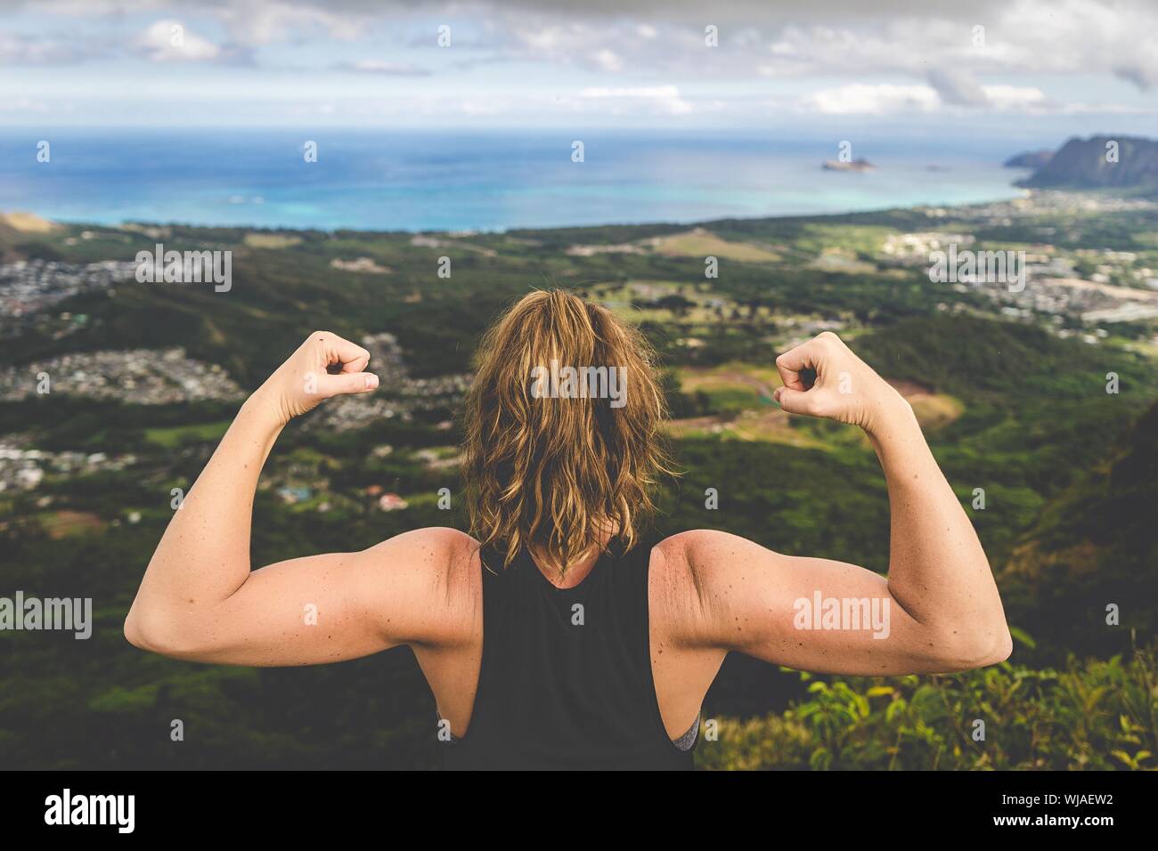 Woman flexing arms hi-res stock photography and images - Alamy