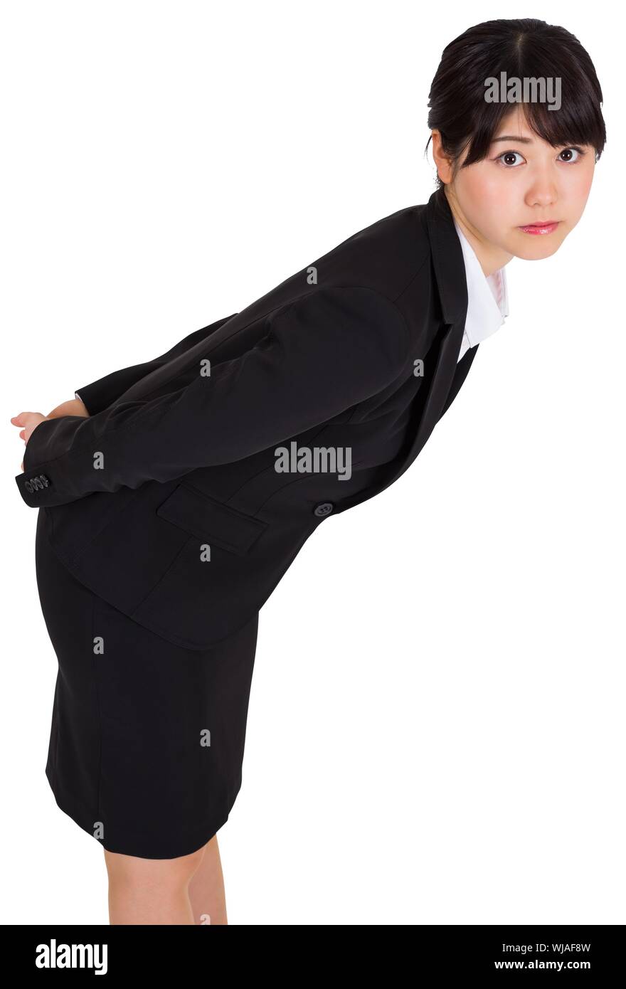 Serious businesswoman bending Stock Photo - Alamy