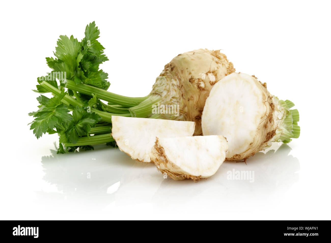 Fresh celeriac root with slice isolated background Stock Photo - Alamy