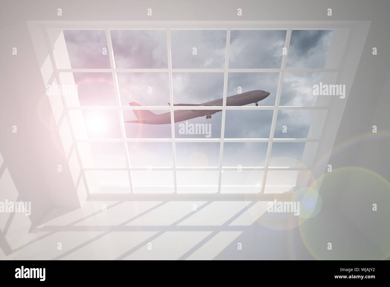 Airplane flying past window Stock Photo - Alamy