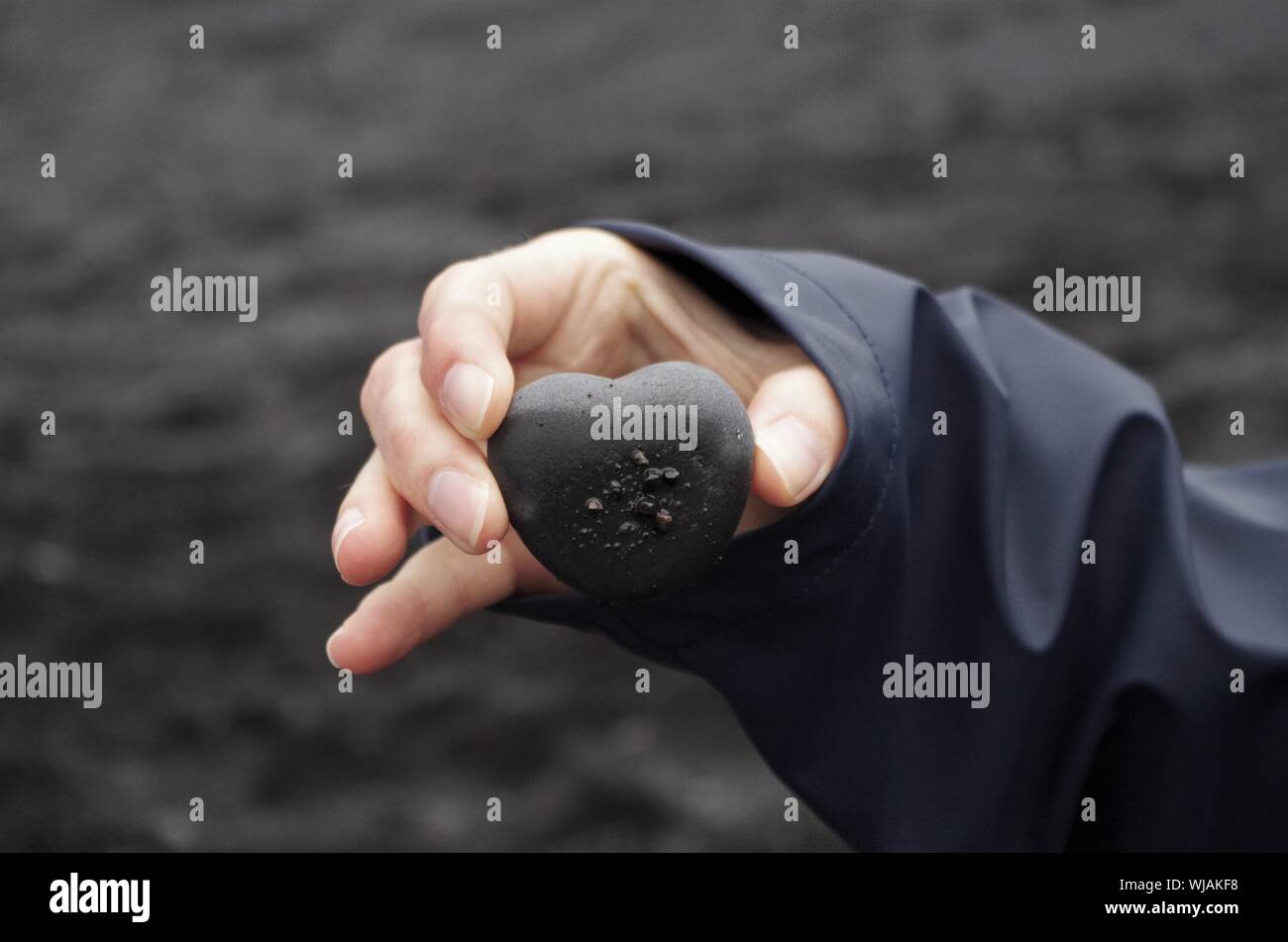Hand holding stone heart hi-res stock photography and images - Alamy
