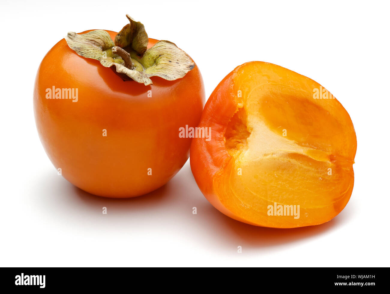 Whole and sliced ripe persimmon fruits isolated on white background ...