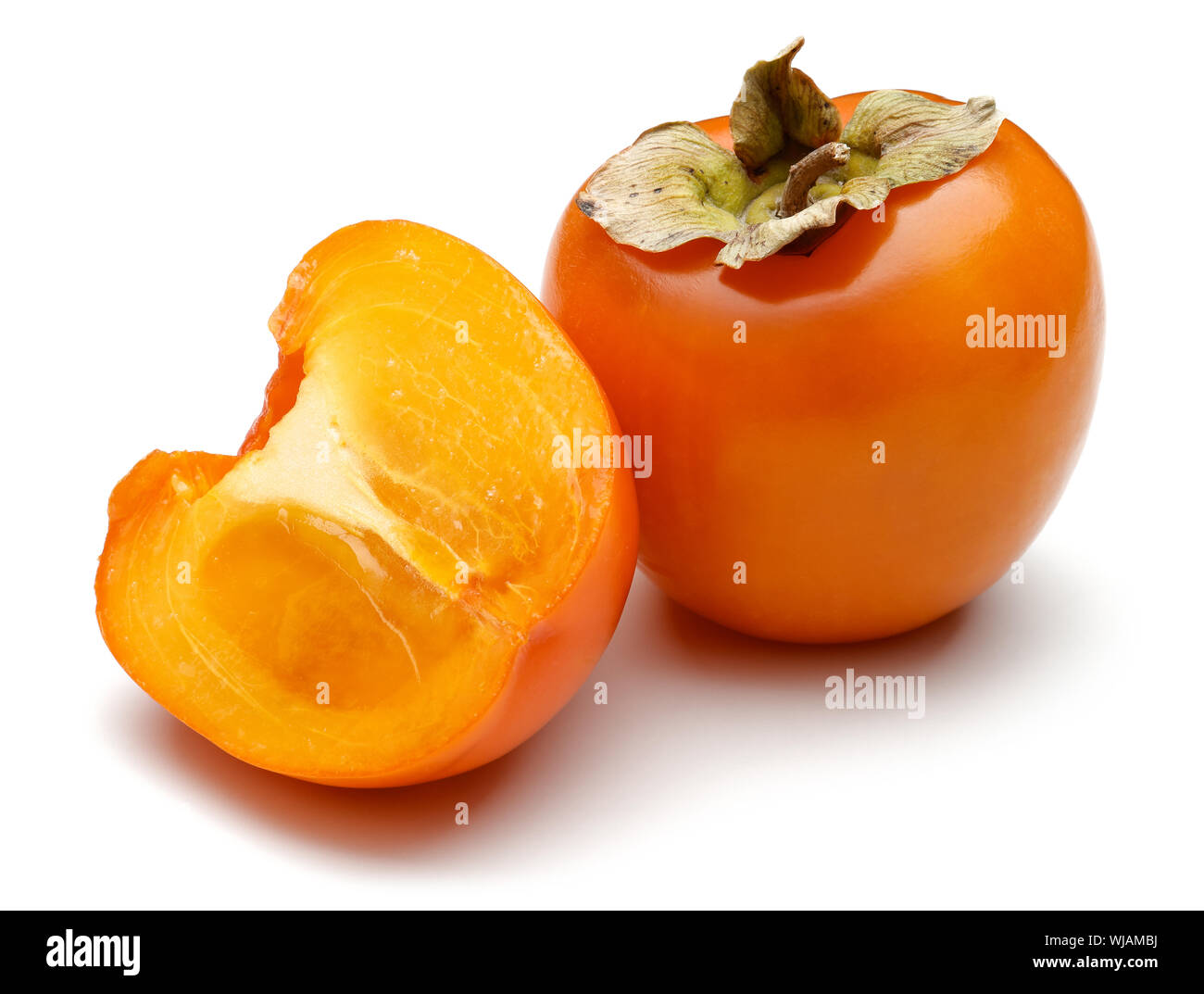 Whole and sliced ripe persimmon fruits isolated on white background ...