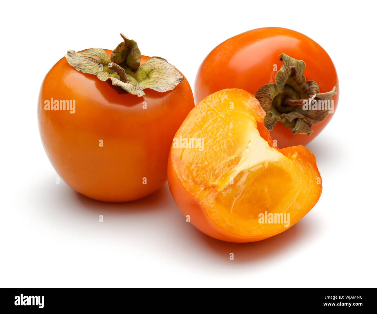 Whole and sliced ripe persimmon fruits isolated on white background ...