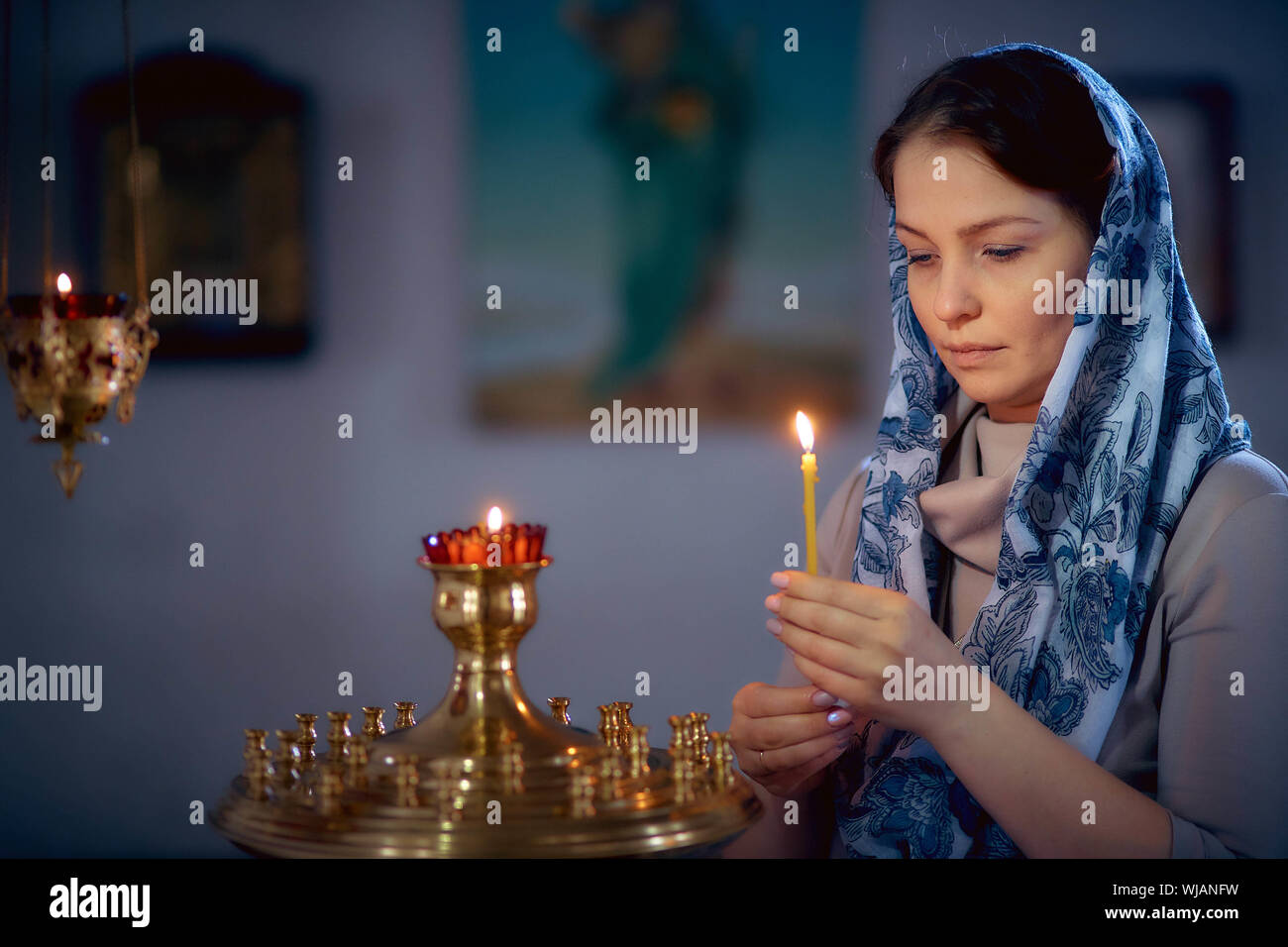 Orthodox woman praying in front of icons in the Church Stock Photo - Alamy