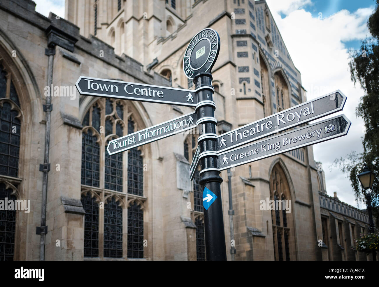 Signpost for Theatre Royal and Greene King Brewery in front of St ...