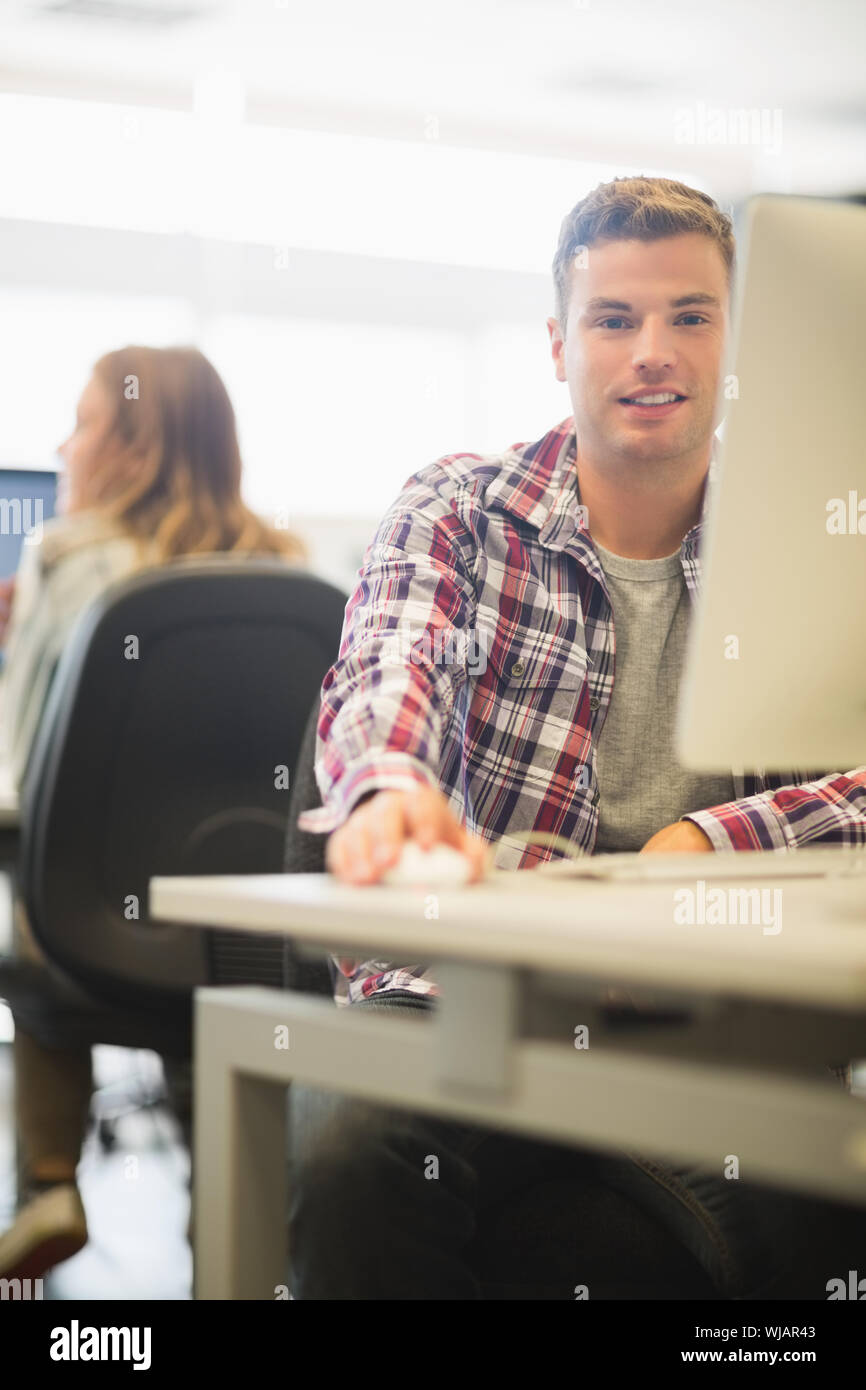 Happy student looking at camera in the computer room Stock Photo - Alamy
