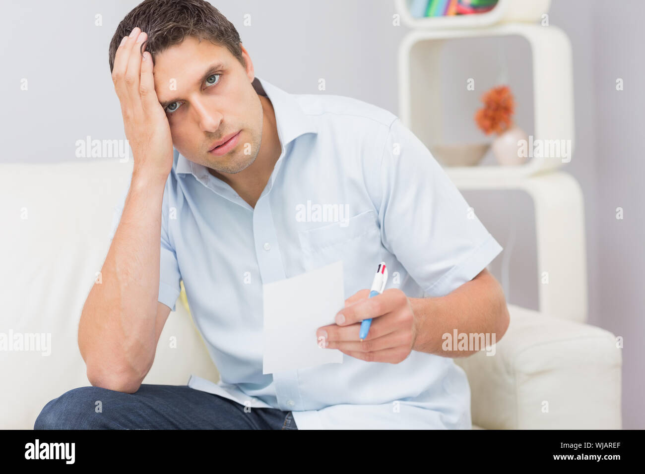 Worried stressed man looking bills hi-res stock photography and images ...
