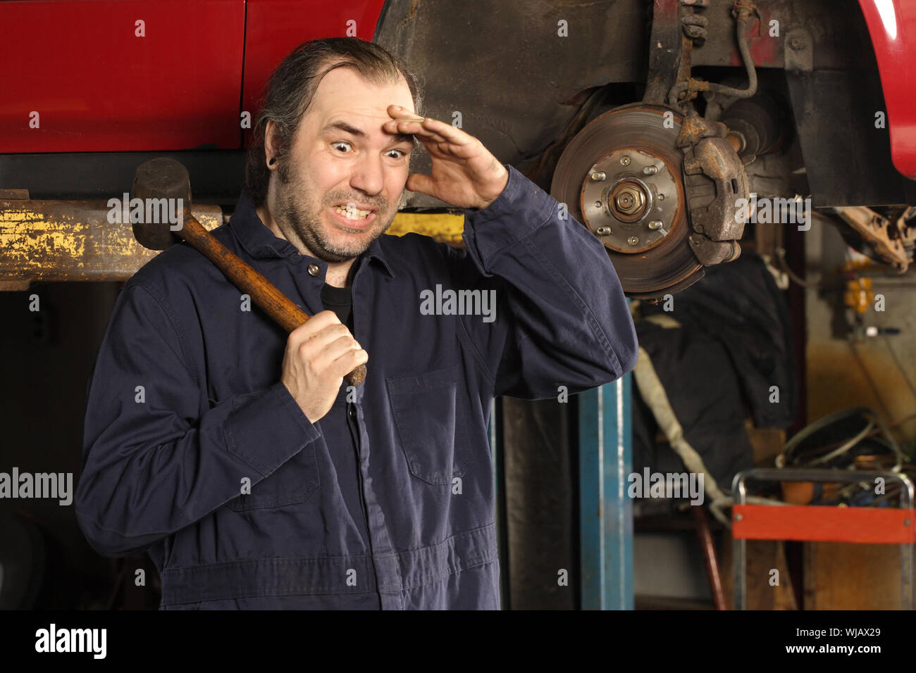 A crazy mechanic confused on what to do to fix the car Stock Photo - Alamy