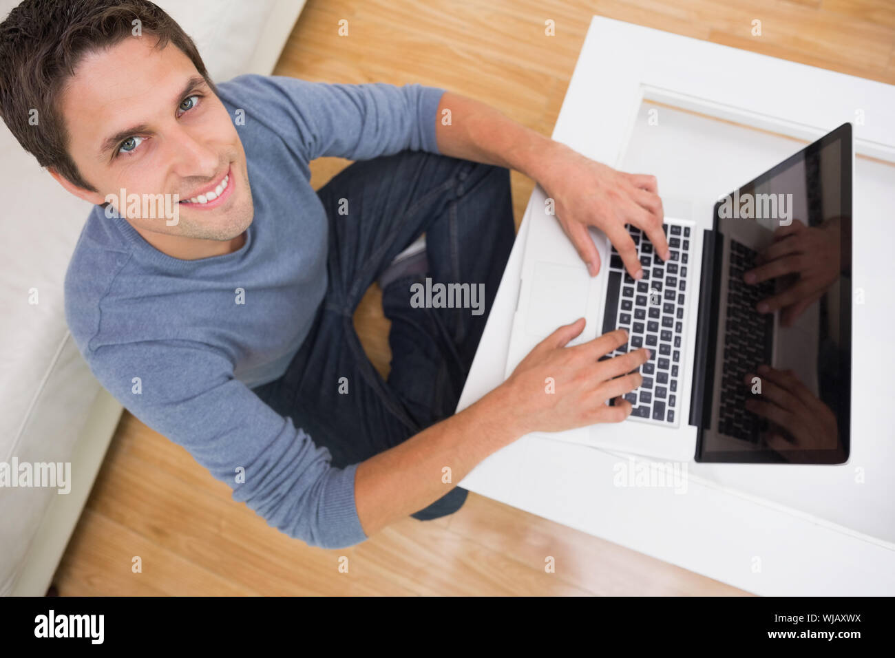 Overhead portrait of a man using laptop in living room Stock Photo - Alamy