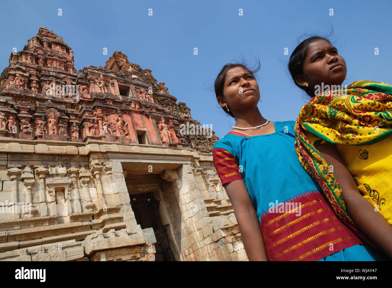 India, Karnataka, Hampi, Portrait of two girls in front of the gopuram ...