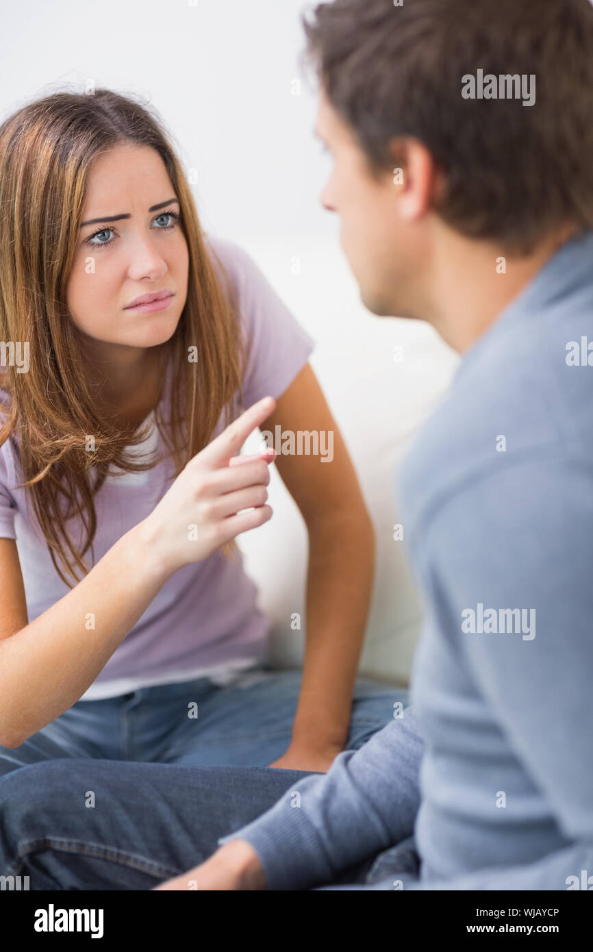Angry couple having an argument in their living room Stock Photo - Alamy