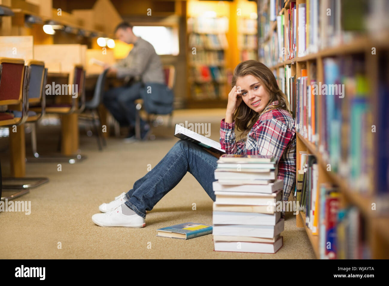 Smiling man reading textbook hi-res stock photography and images - Alamy
